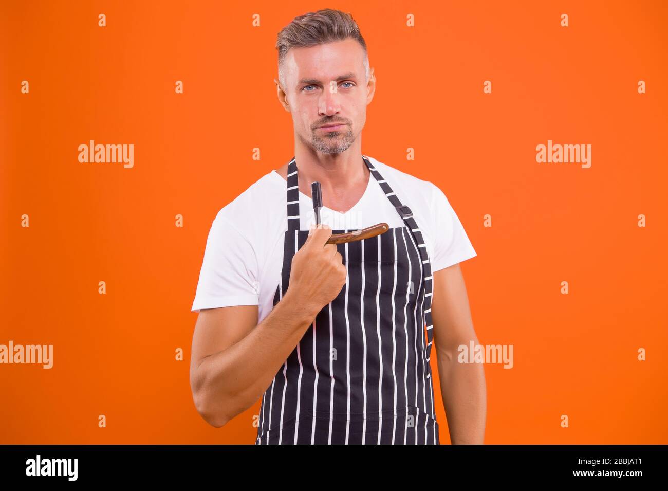 Barbershop style starts here. Barber hold razor orange background ...