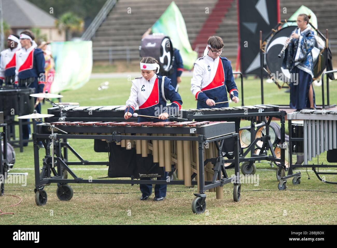 Asian American teenage girl plays the marimba in a high school marching ...