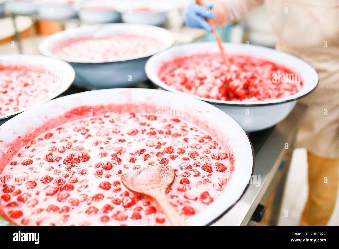 Strawberry jam cooking process. Organic traditional jam manufacturing ...