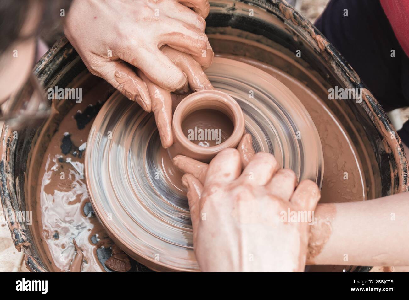 A close up view on ceramic production process on potter's wheel with ...
