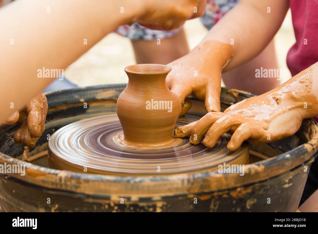 A close up view on ceramic production process on potter's wheel with ...
