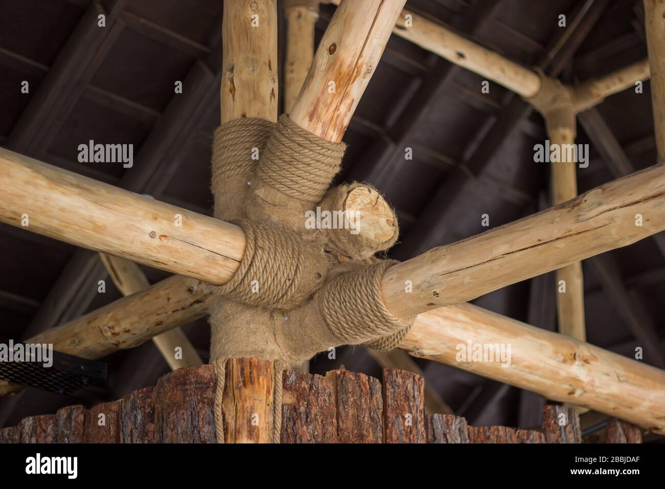 View of wooden log rafters when installing roof on construction of ...