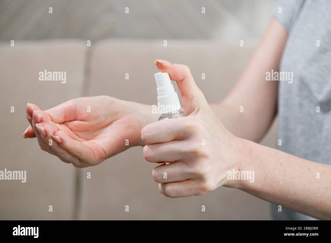 Apply sanitizer spray liquid at hand palm Stock Photo - Alamy