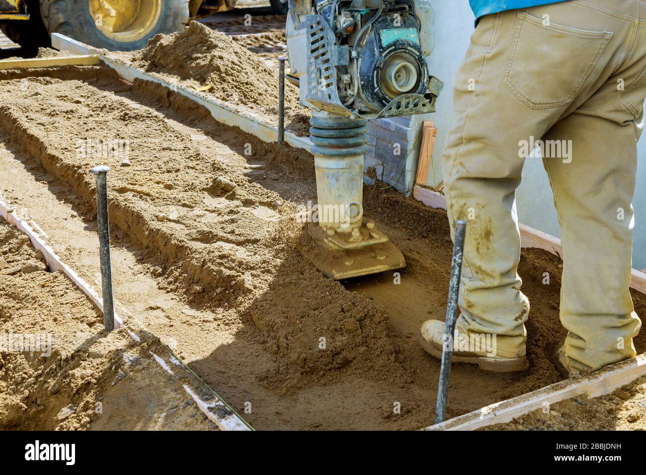 Compaction ground with vibration plate compactor machine on sidewalk ...