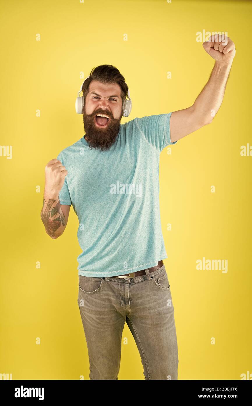 Born to win. Happy winner listen to music. Bearded man make winner ...