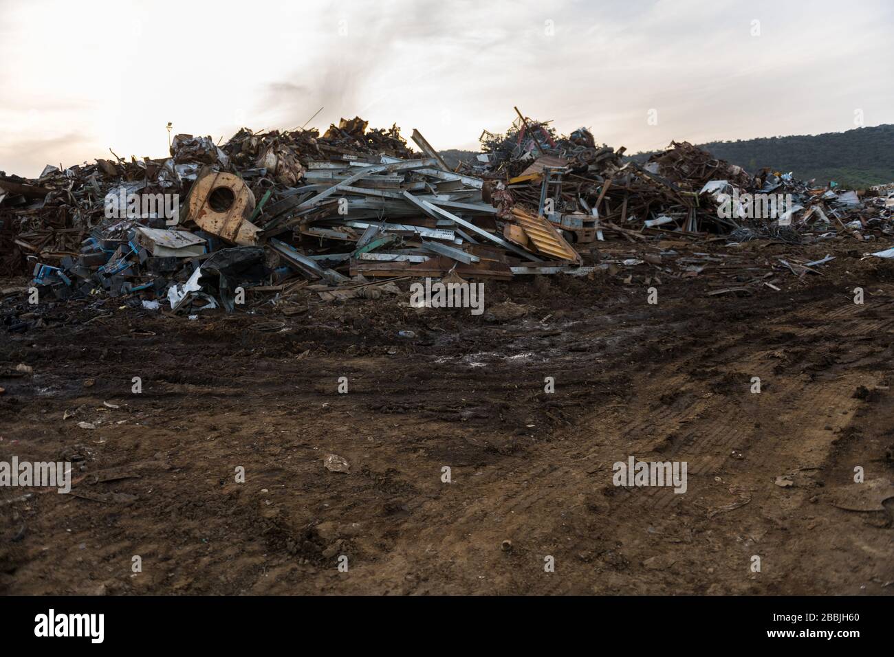 Sunset view of the mountains of scrap metal in a junkyard Stock Photo ...