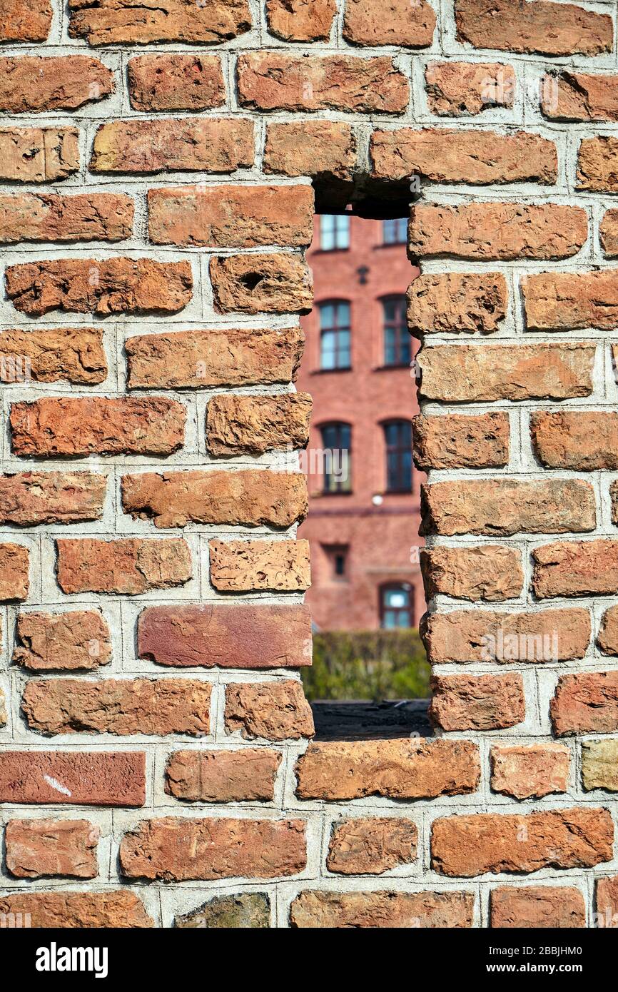Narrow shooting window in the wall of a medieval tower in the city of ...