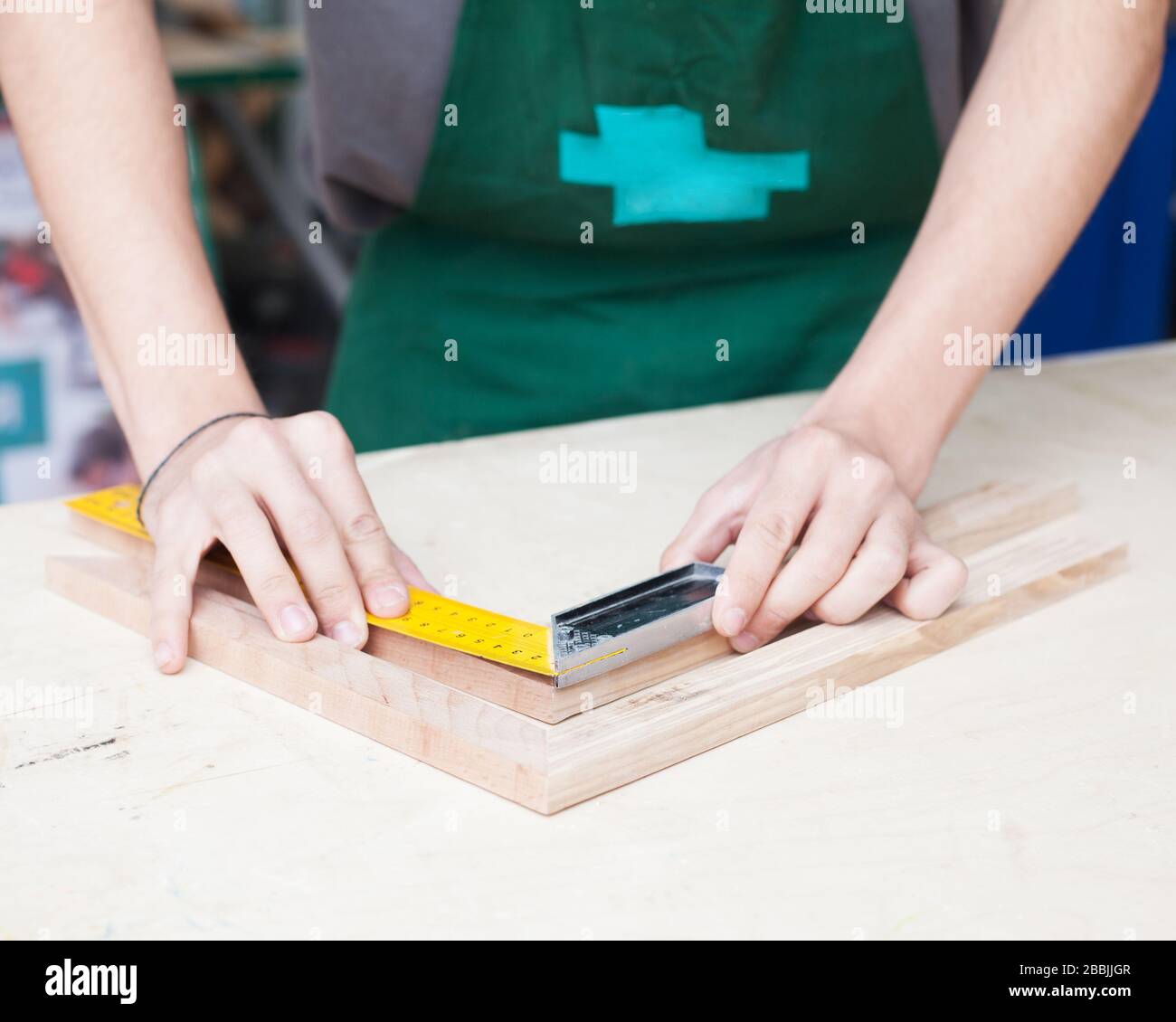 The carpenter in the workshop works with tools, makes measurements ...