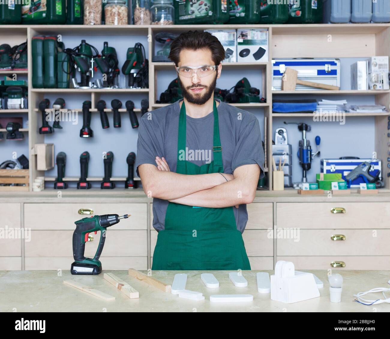 Portrait of a carpenter master with a beard in work clothes in a ...