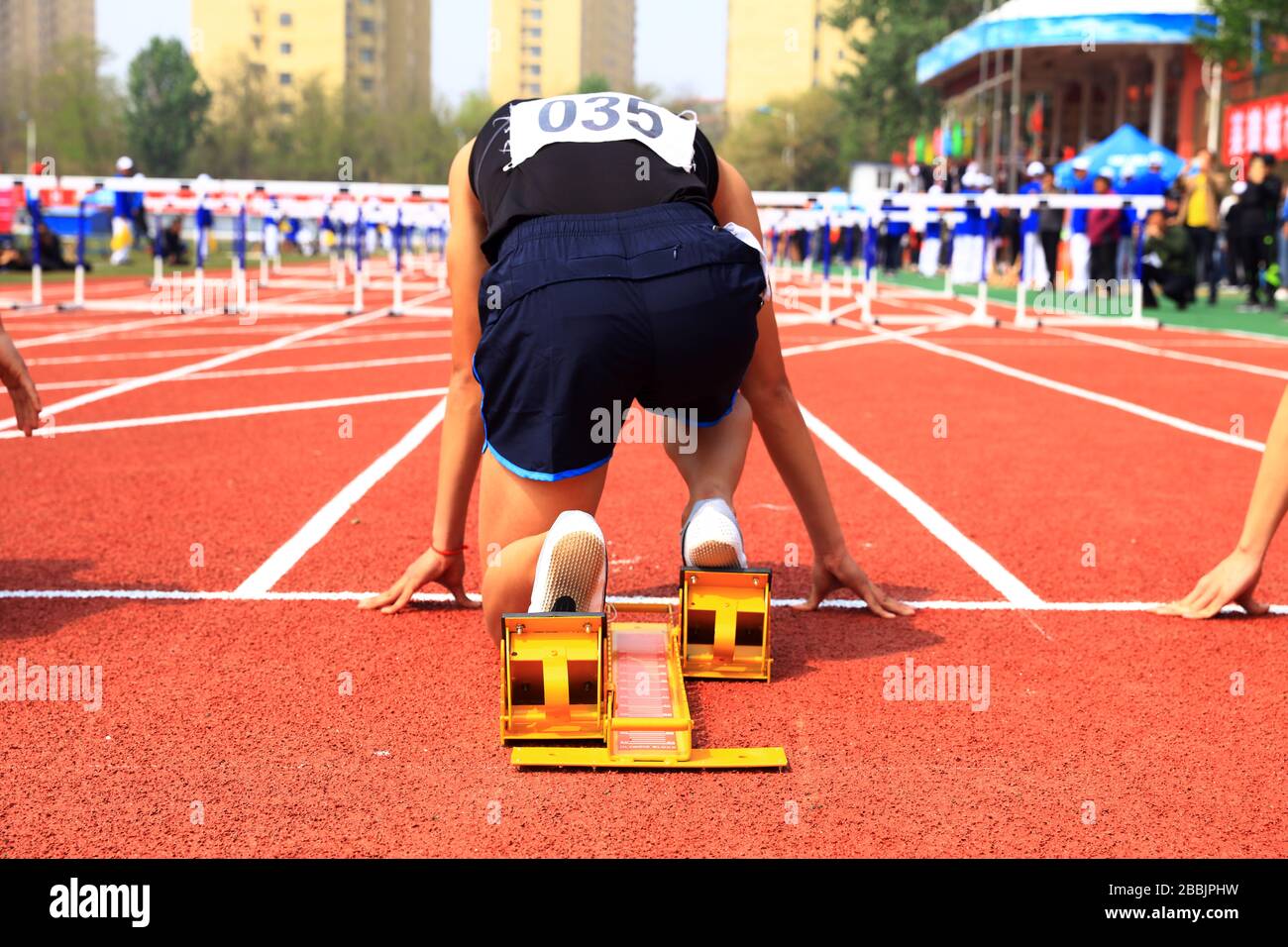 The athletes are at the starting line of the stadium Stock Photo - Alamy