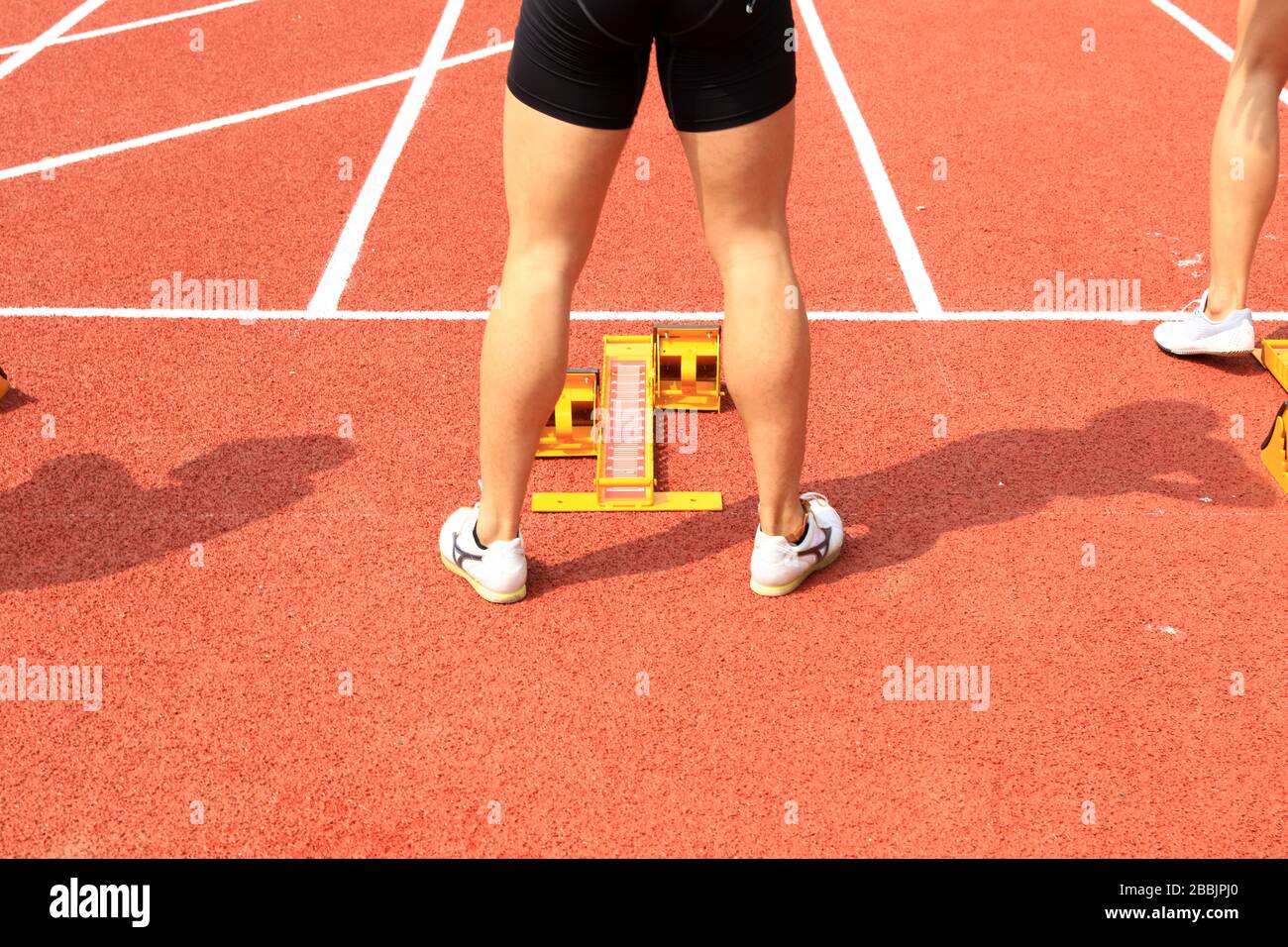The athletes are at the starting line of the stadium Stock Photo - Alamy
