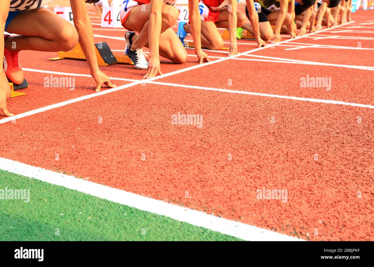 The athletes are at the starting line of the stadium Stock Photo - Alamy