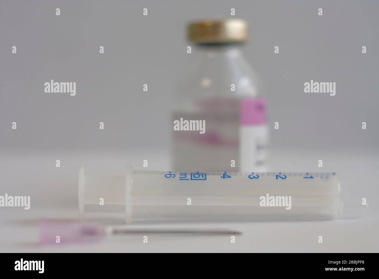 Close up of syringe, on background vial of antibiotics, injection drugs ...