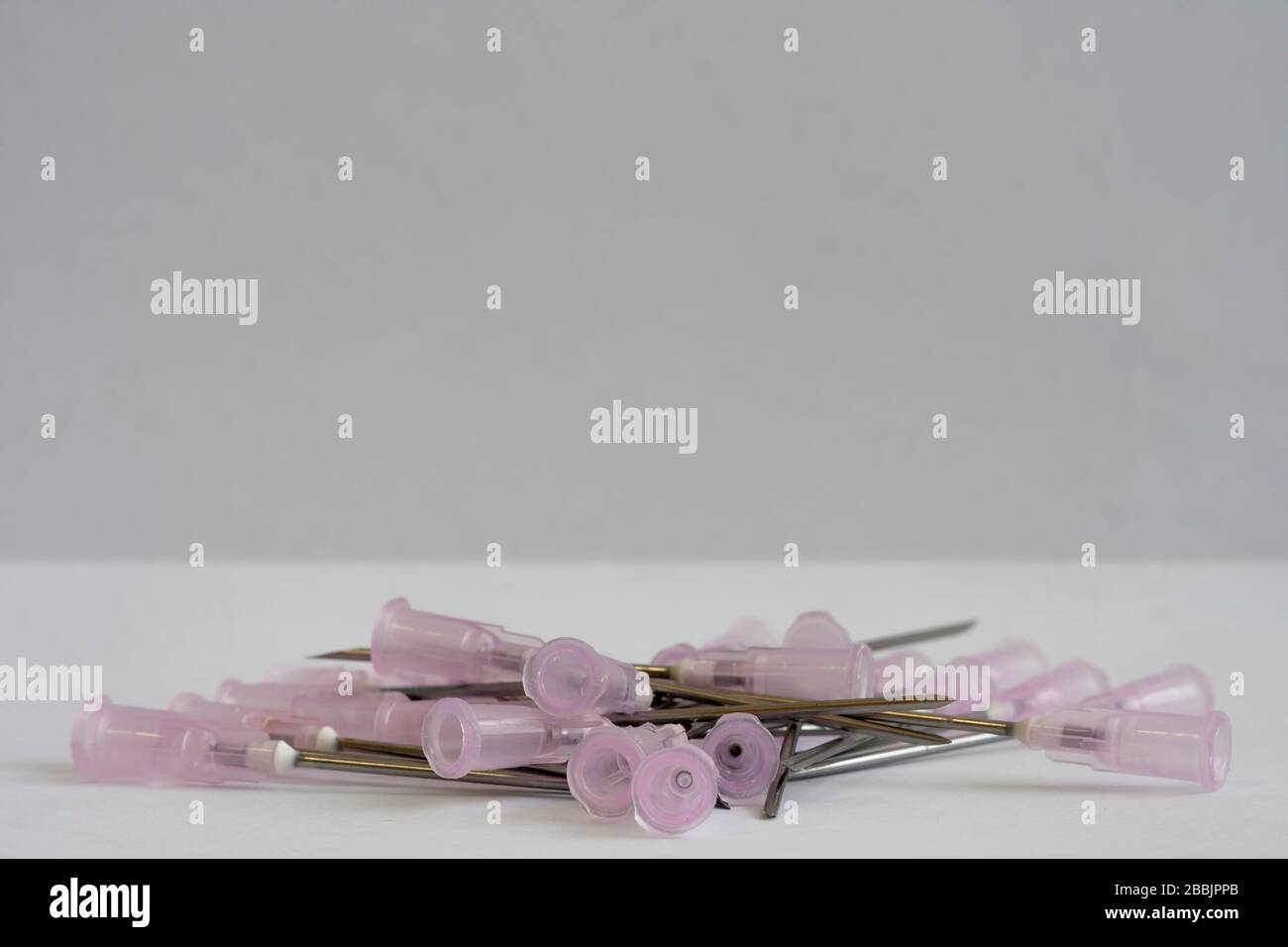 Close up of several of medical injection needles on white background ...