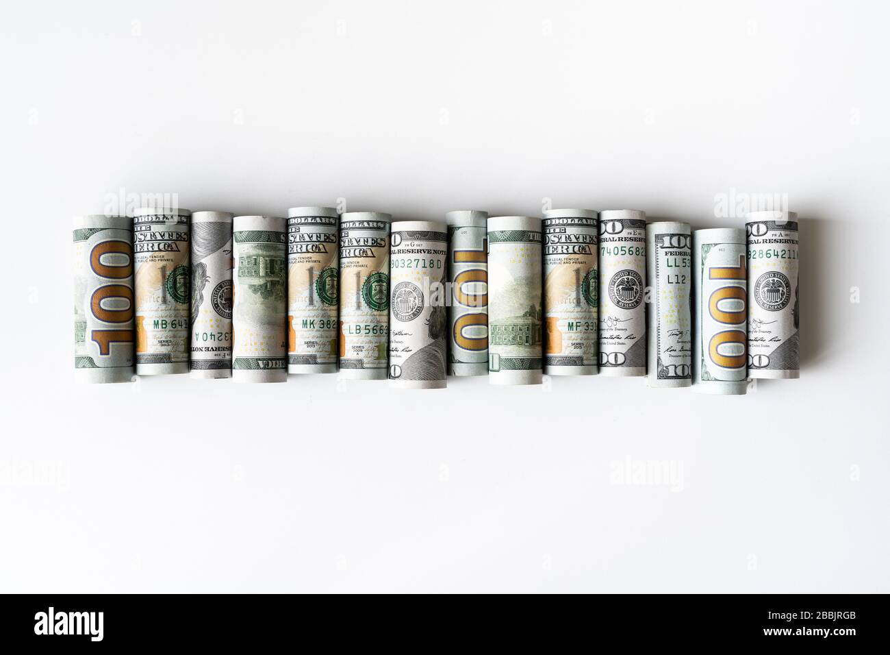 Rolls of US dollar bill in a row Stock Photo - Alamy