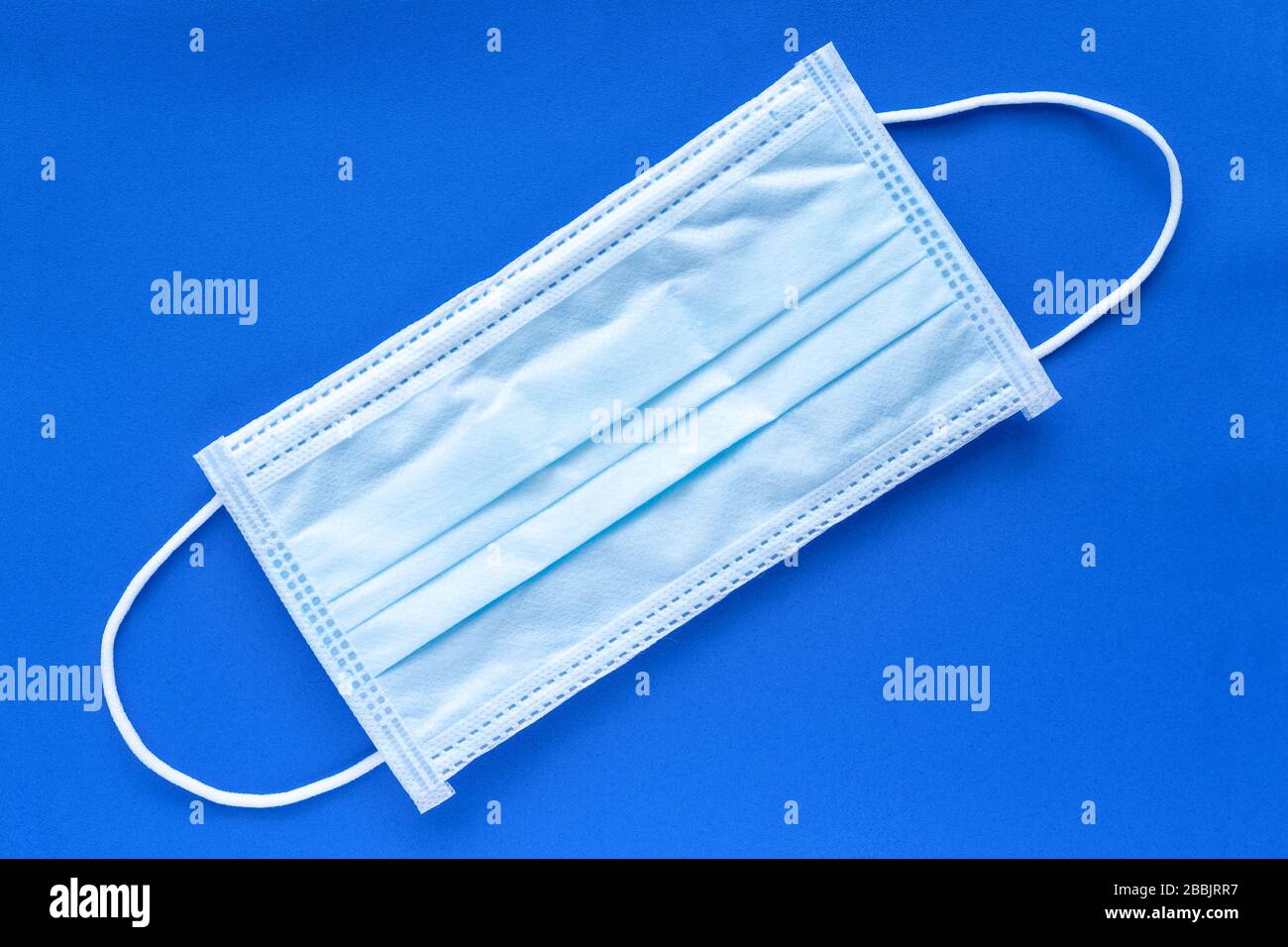 Typical 3 ply surgical face mask with rubber ear straps Stock Photo - Alamy