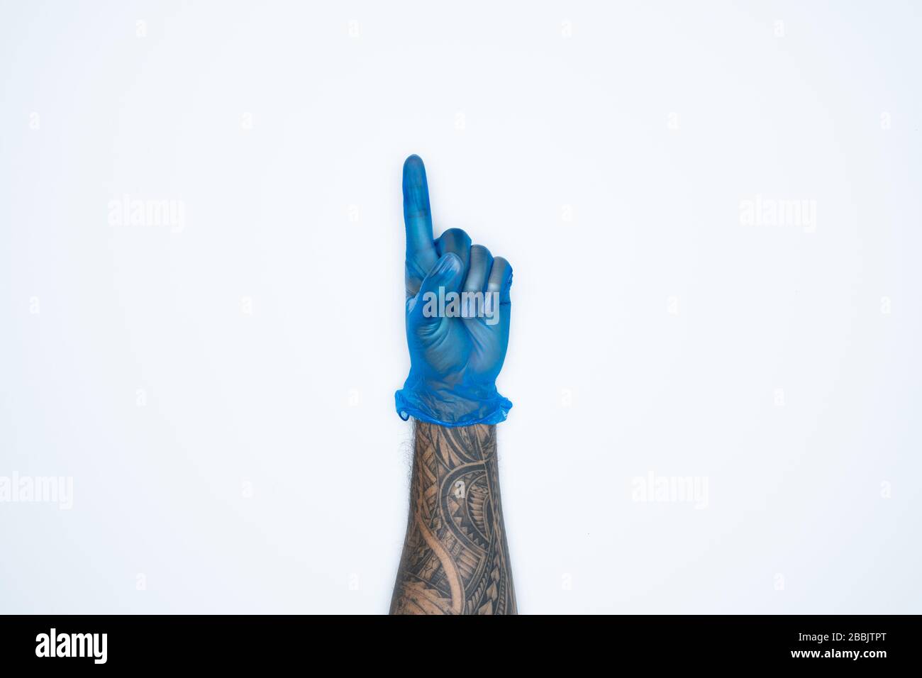 A man hand and gestures in Blue rubber glove shows one finger sign ...