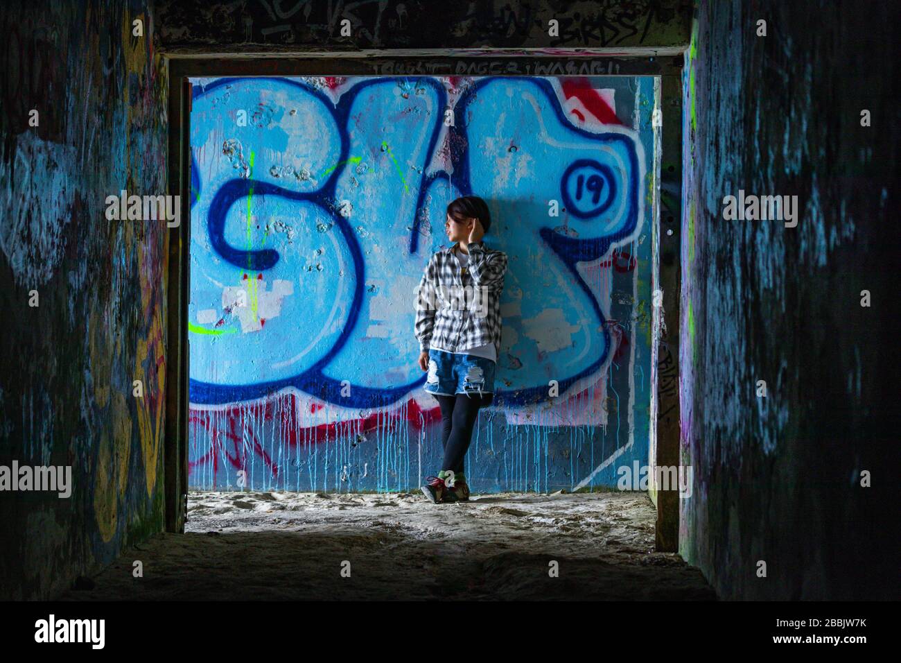 Young graffiti art in a bunker Stock Photo - Alamy