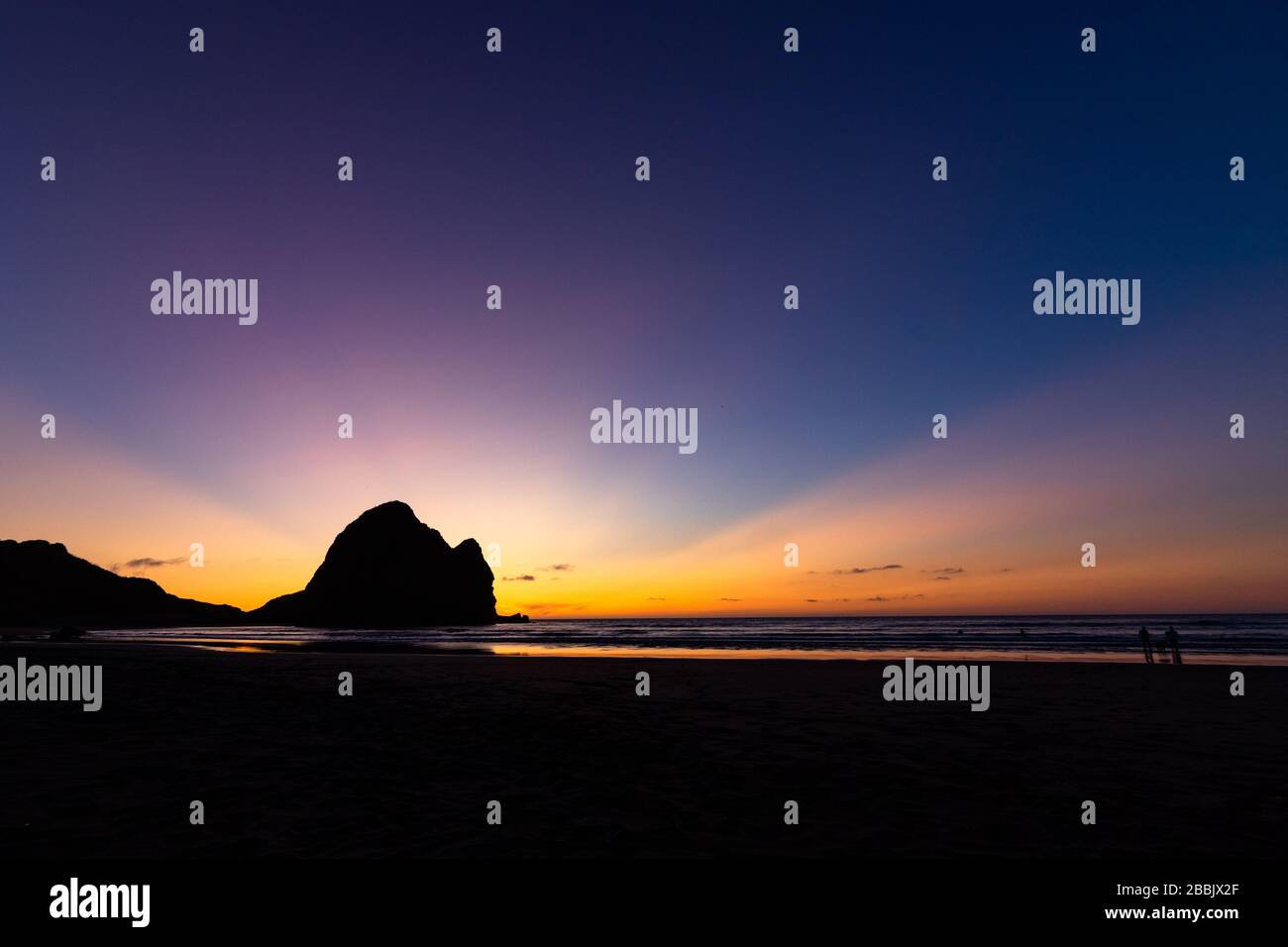 sunset at the beach of piha Stock Photo - Alamy