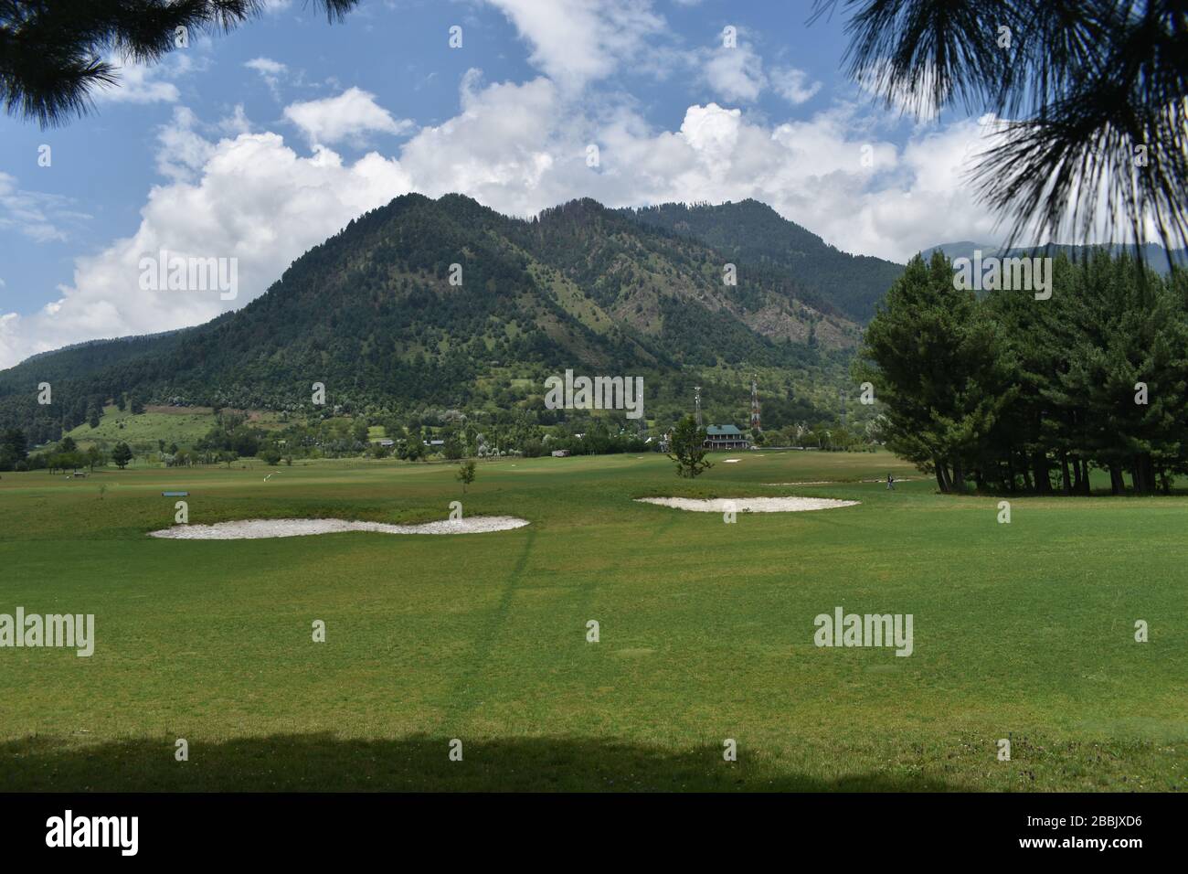 A beautiful view of lush green golf course sourrended by beautiful ...