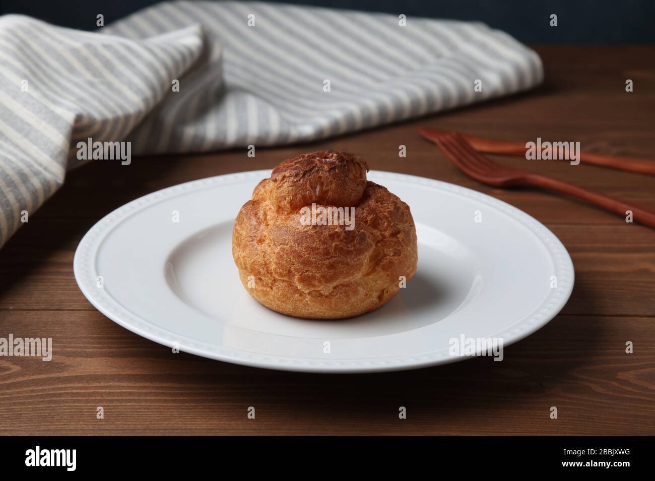 cream puff on plate closeup isolated on white background Stock Photo ...