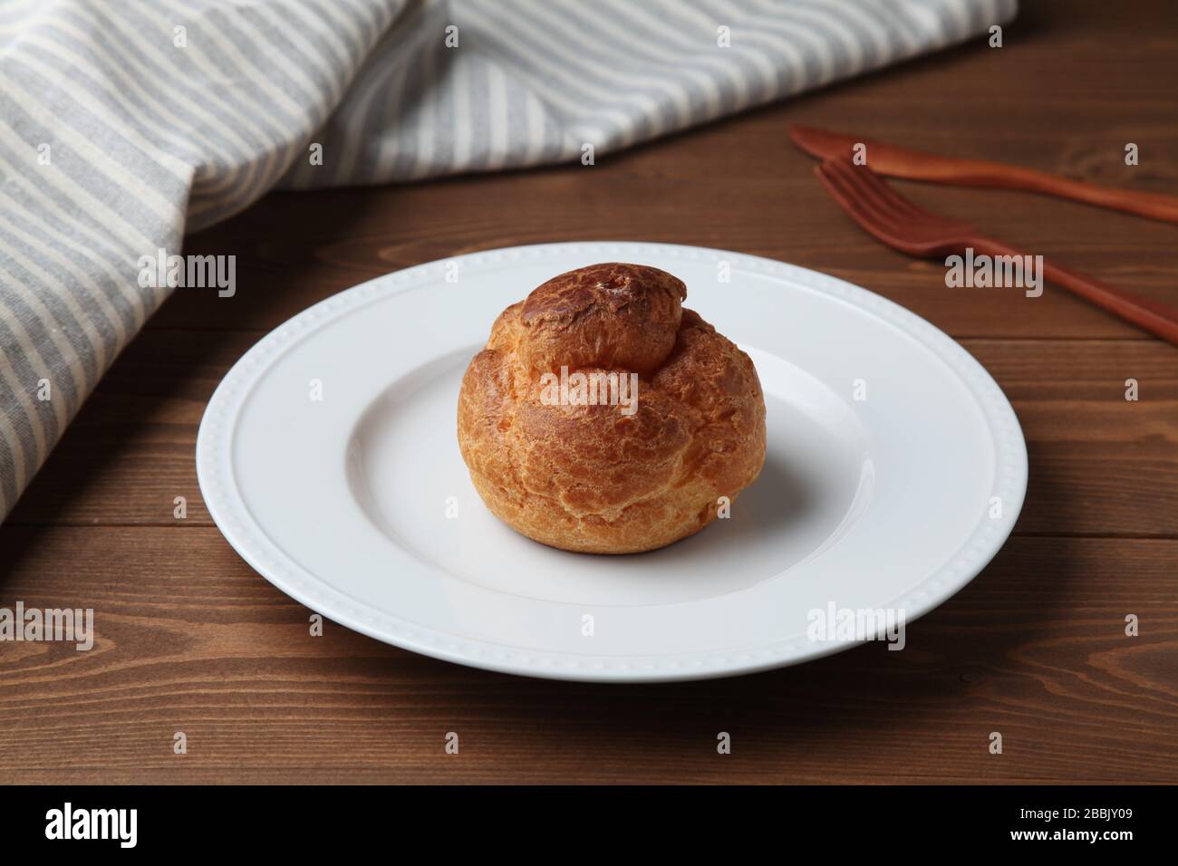 cream puff on plate closeup isolated on white background Stock Photo ...
