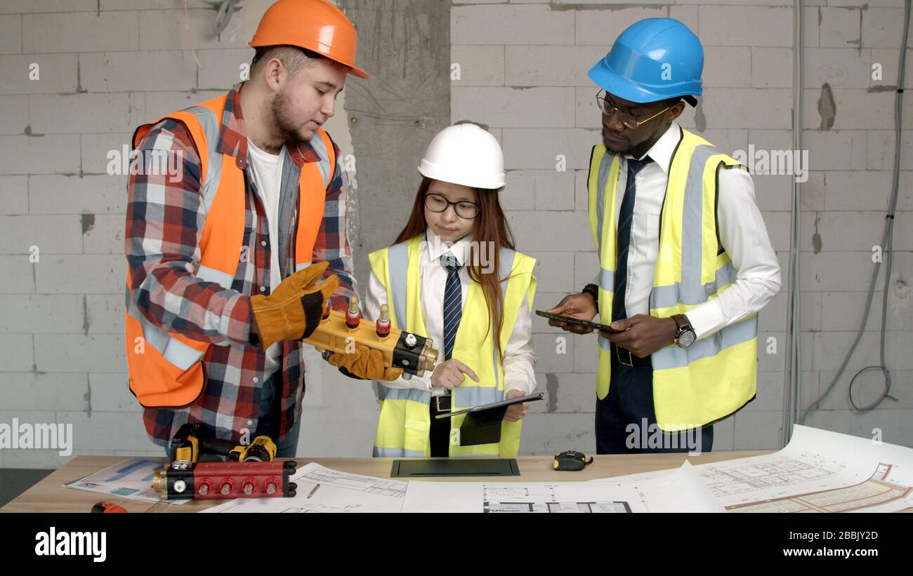 Young architects checking blueprints equipment hi-res stock photography ...