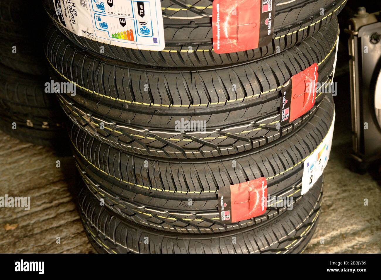 Stack of car four tyres in garage environment t Stock Photo - Alamy