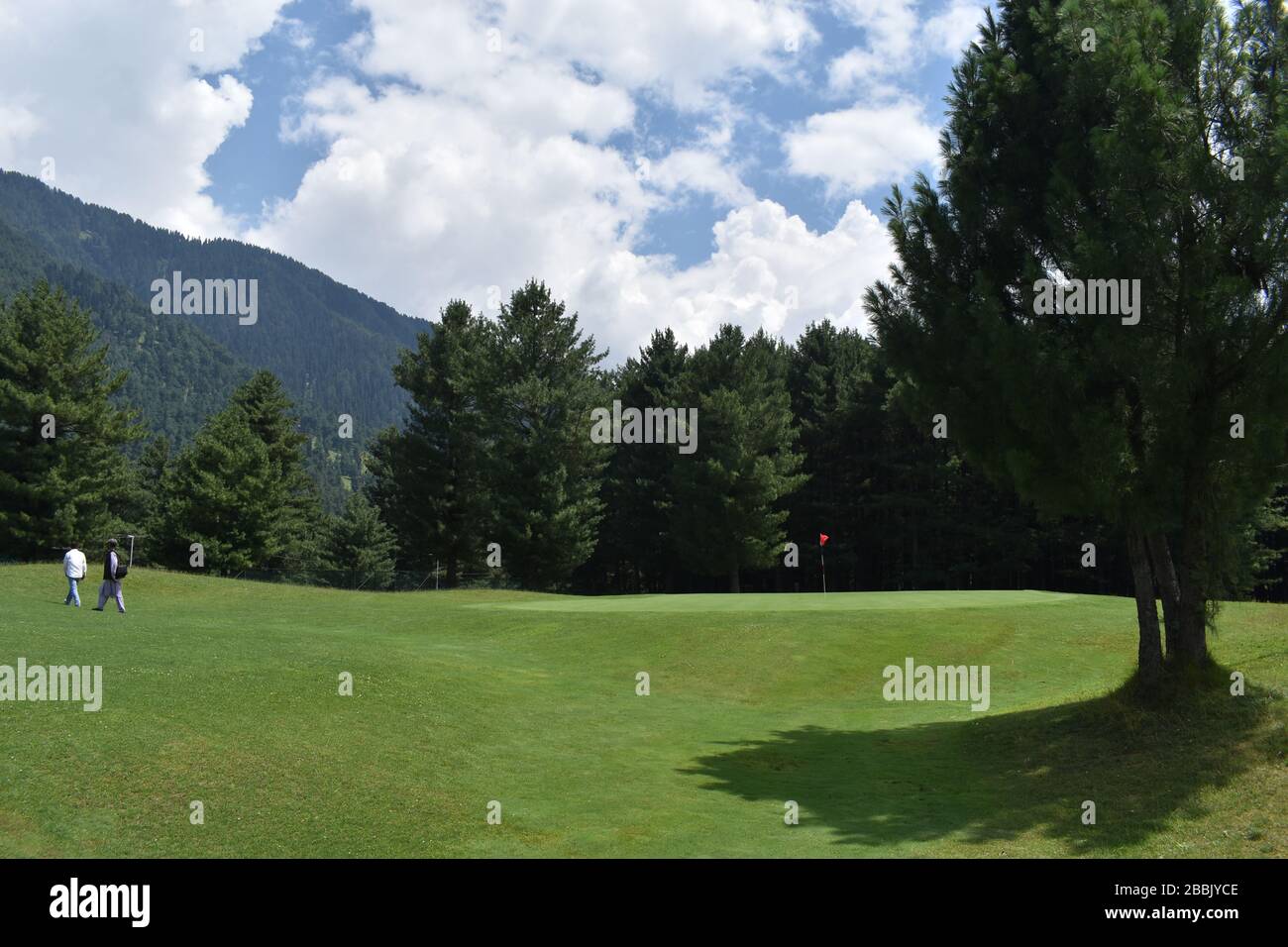 A beautiful view of lush green golf course sourrended by beautiful ...
