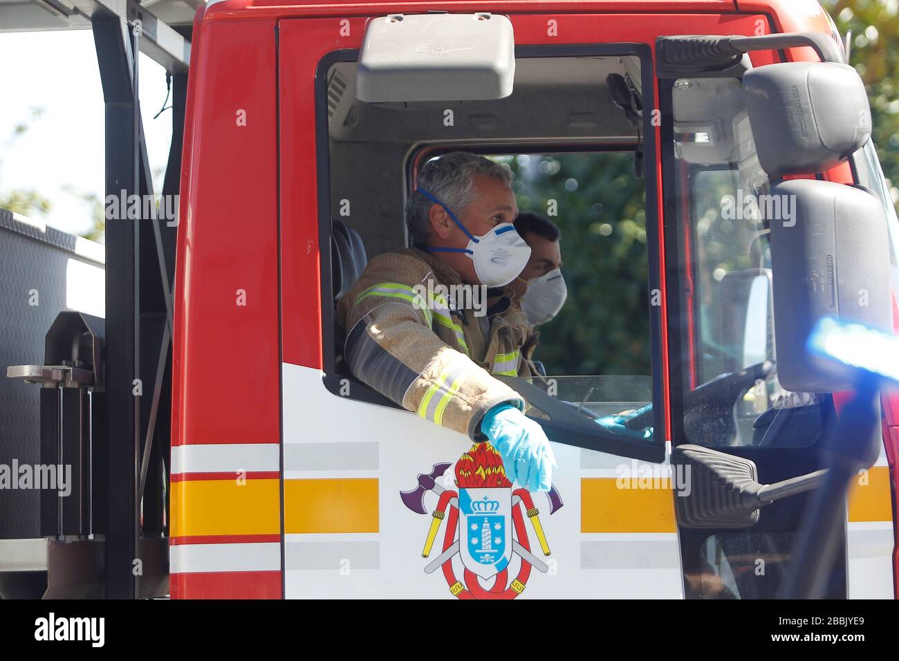 A Coruna-Spain.Firefighters with masks inside fire trucks during a ...