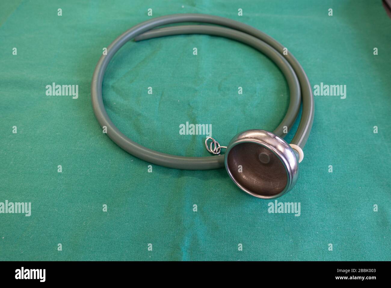on a green surgical drape lies a suction cup for the birth Stock Photo ...
