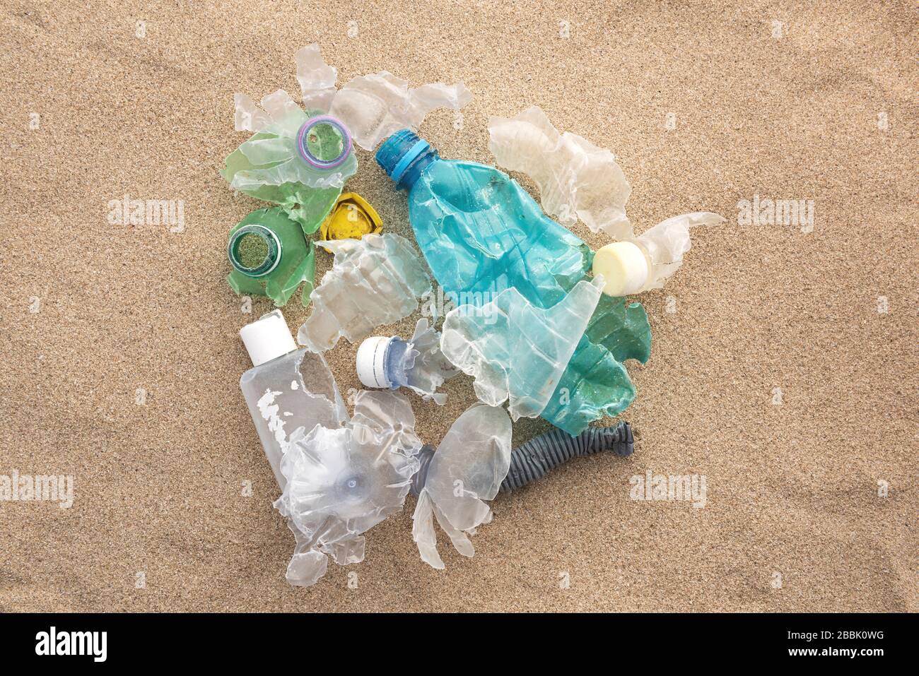 Heap of plastic garbage on sand, global pollution concept Stock Photo ...