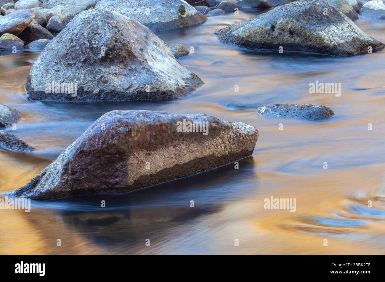 Autumnal color bounce of the water surface at Merced River, Yosemite ...