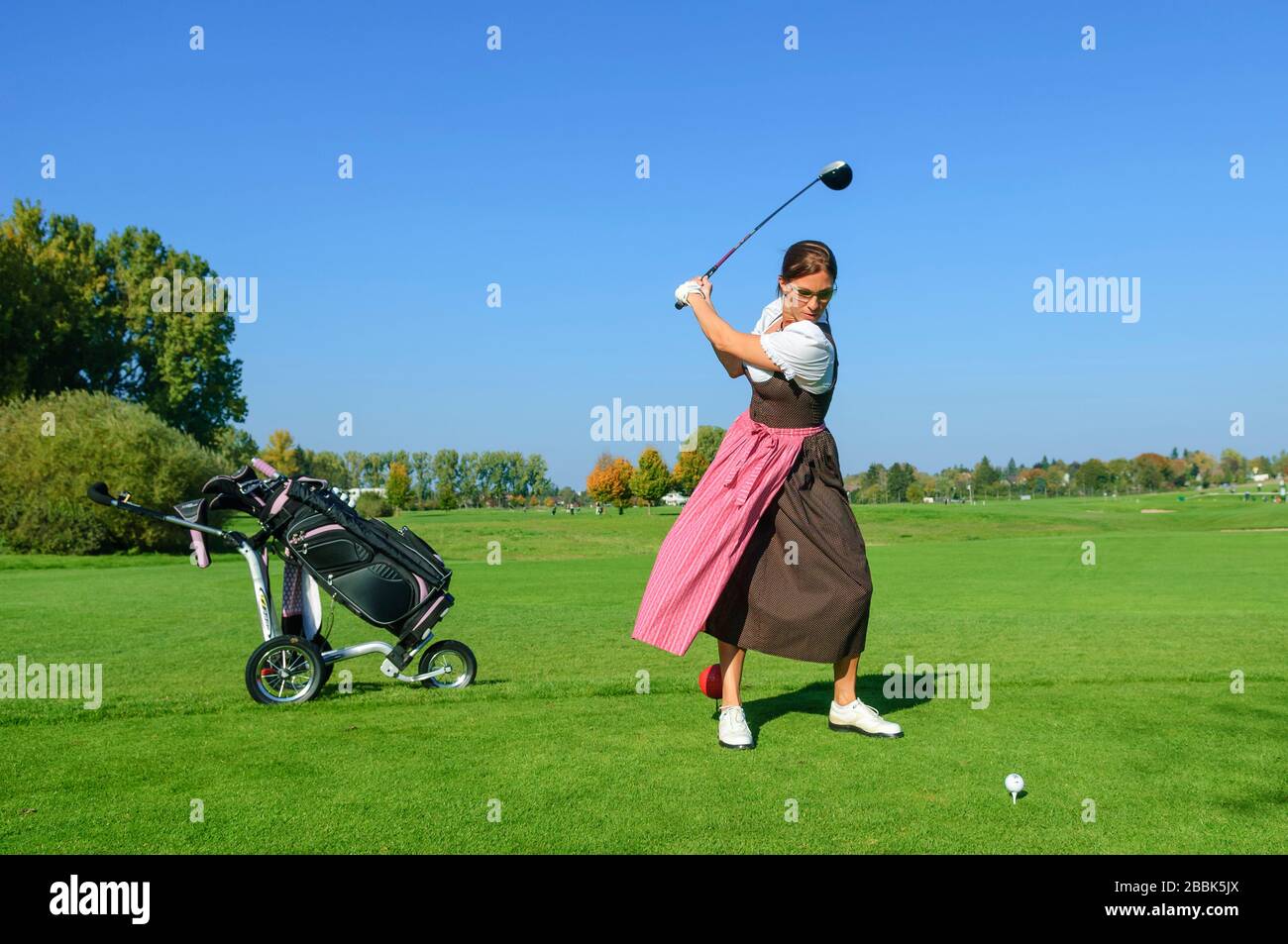 Female golf player playing in traditional dress Stock Photo - Alamy