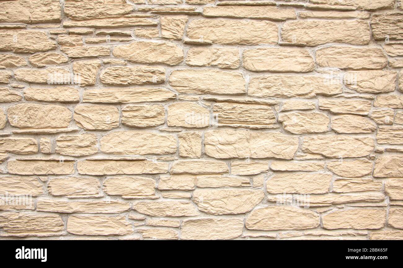 Texture of stone wall, square yellow travertine tile Stock Photo - Alamy