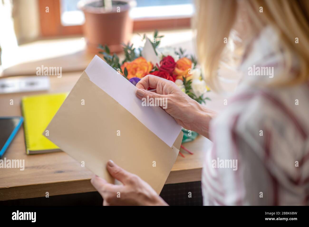 Female hands opening paper envelope with letter Stock Photo - Alamy