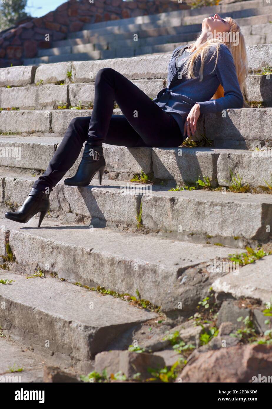 Beautiful young girl sitting on stone steps Stock Photo - Alamy