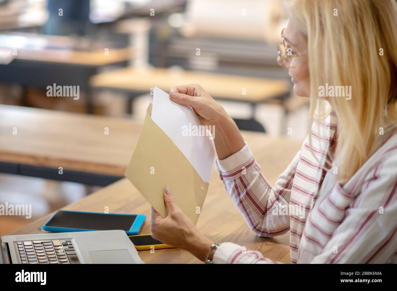 Female hands opening envelope with letter near computer Stock Photo - Alamy
