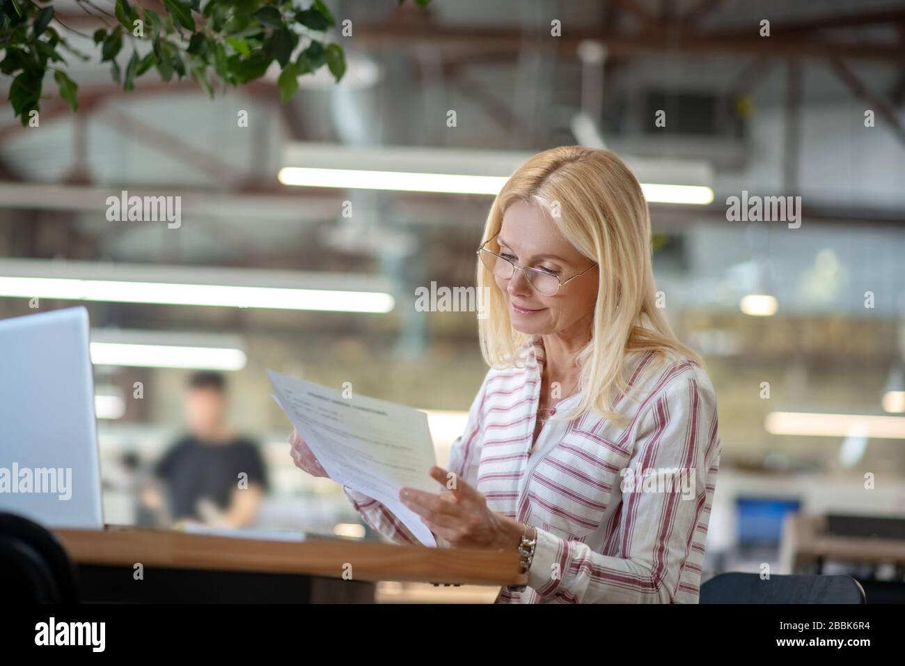 Woman looking through papers hi-res stock photography and images - Alamy