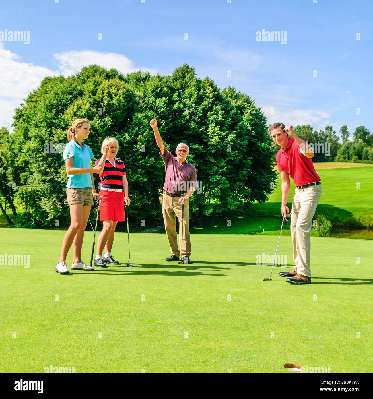 A group of golfers playing on green Stock Photo - Alamy