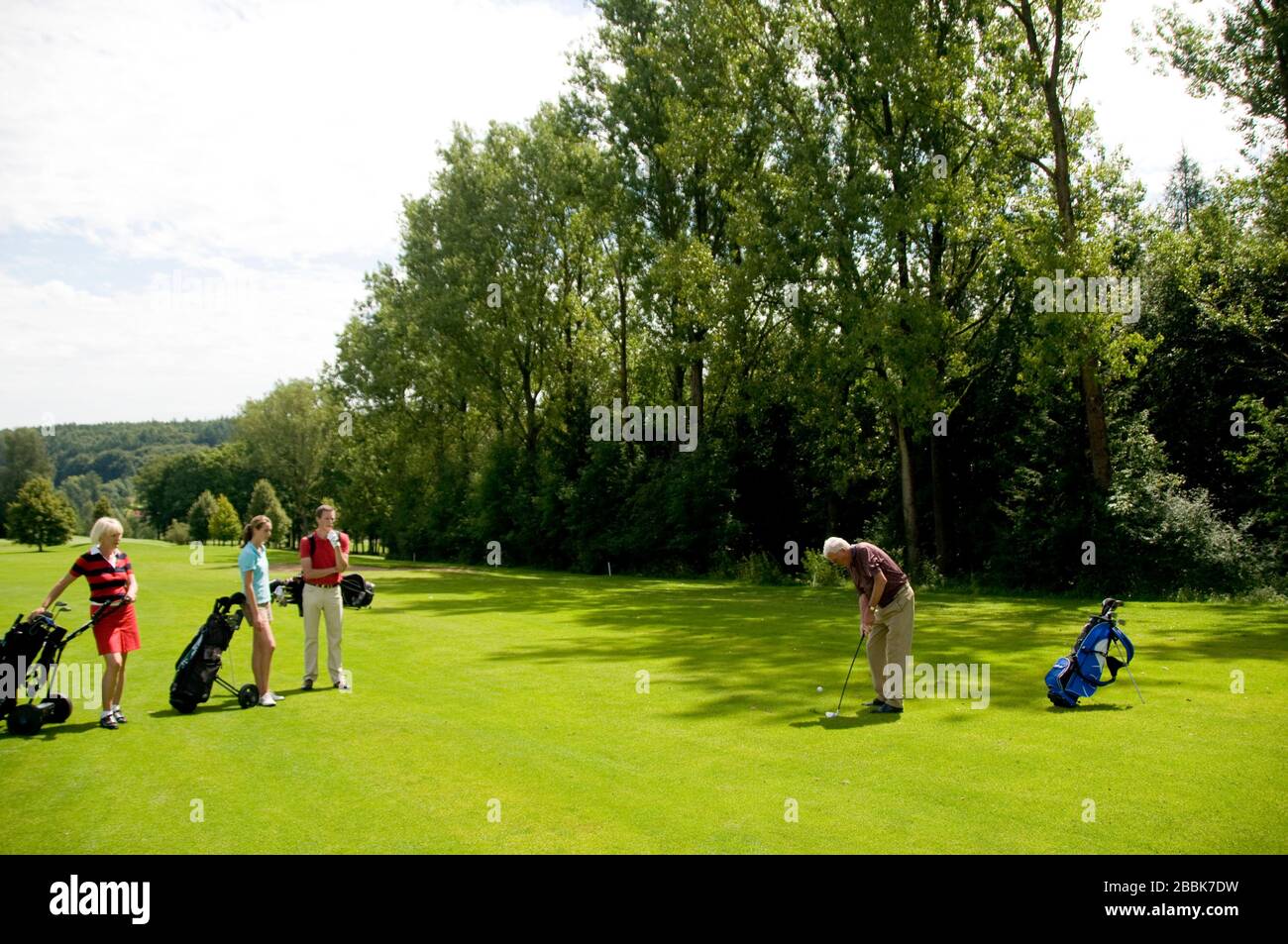 Golf flight playing on fairway Stock Photo - Alamy