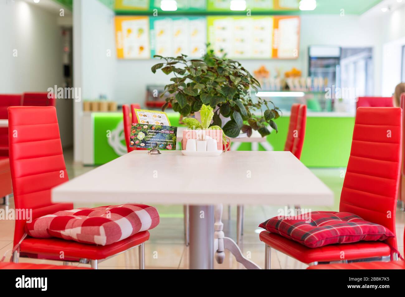 Modern design restaurant interior in white and red colors with plants ...