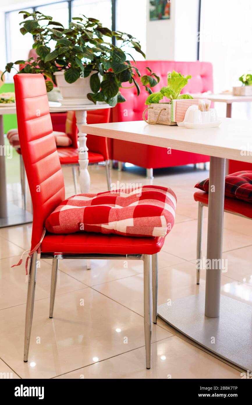 Modern design restaurant interior in white and red colors with plants ...