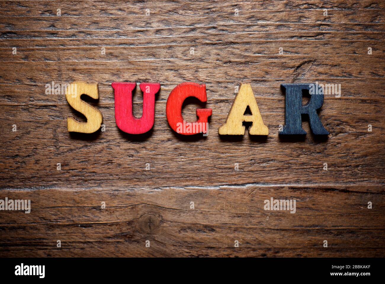 Sugar word on a wood table Stock Photo - Alamy