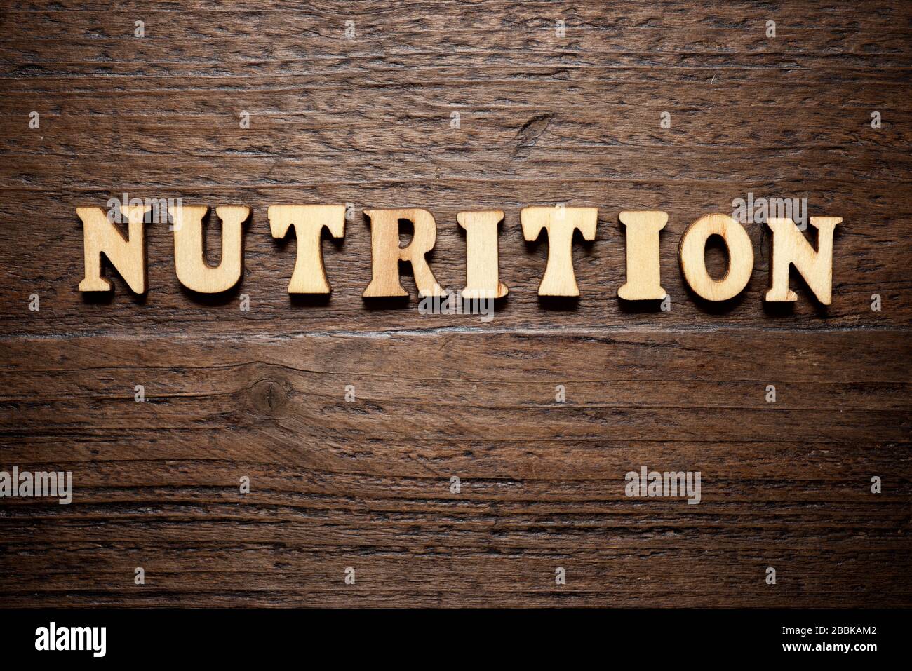 Nutrition word on a wood table Stock Photo - Alamy