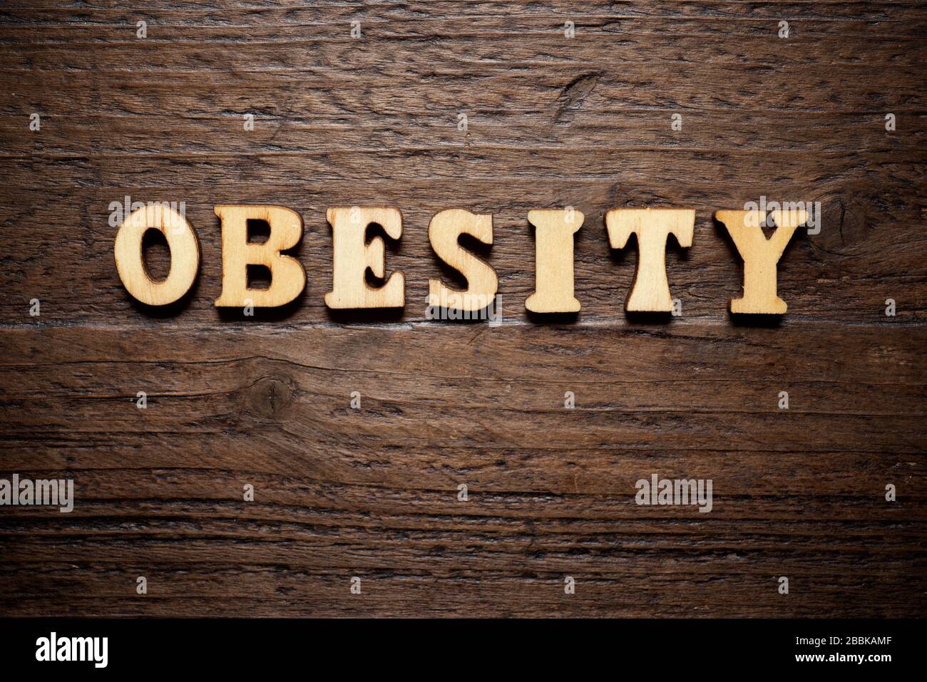 Obesity word on a wood table Stock Photo - Alamy