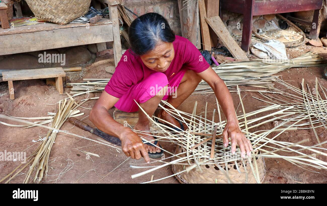 Bamboo basket craftswoman while doing his work in a place Stock Photo ...