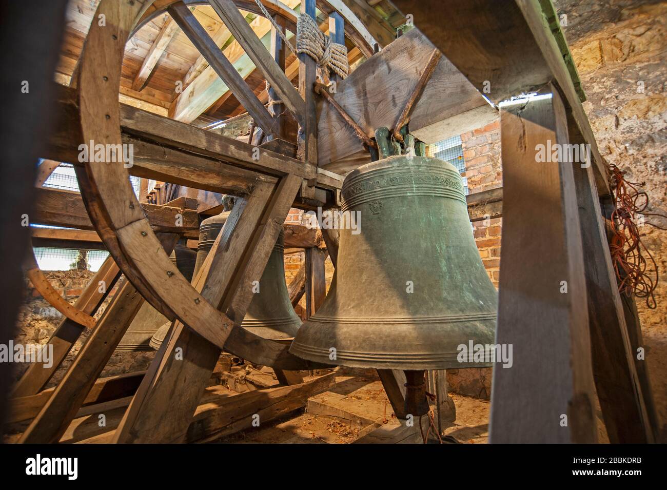 Traditional large old bells hanging in an english church tower from the ...
