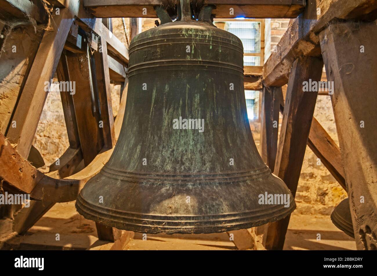 Traditional large old bells hanging in an english church tower from the ...