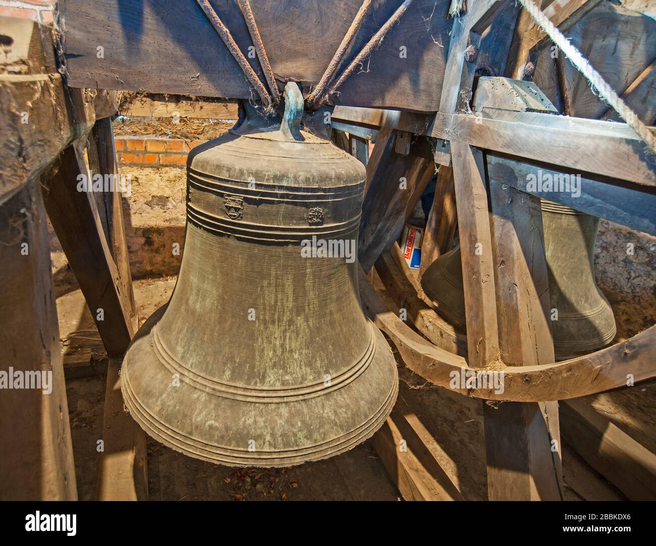 Traditional large old bells hanging in an english church tower from the ...